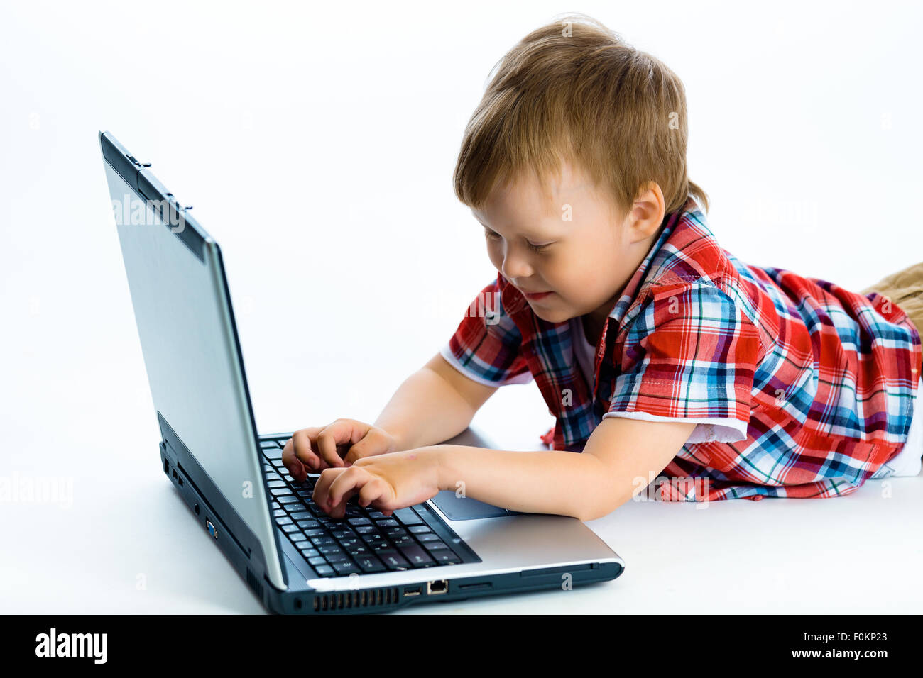 Little boy lying on the floor with a laptop Stock Photo - Alamy