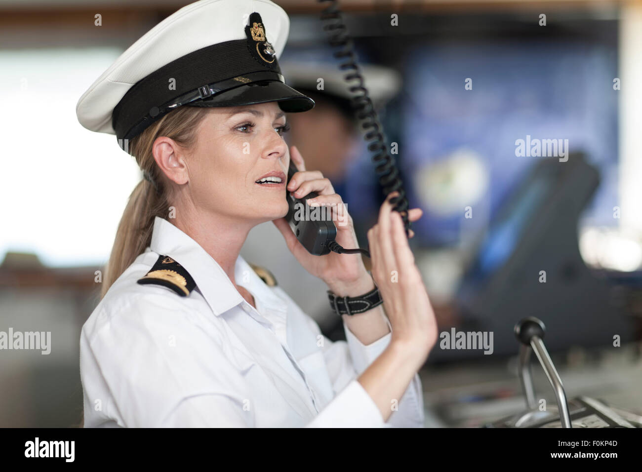 Chief mate on bridge talking on radio Stock Photo - Alamy