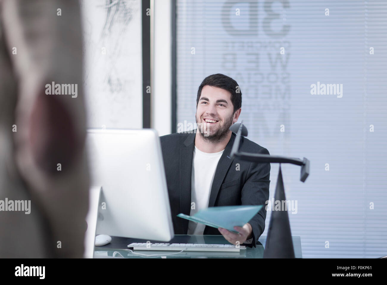 Man in office behind computer Stock Photo - Alamy