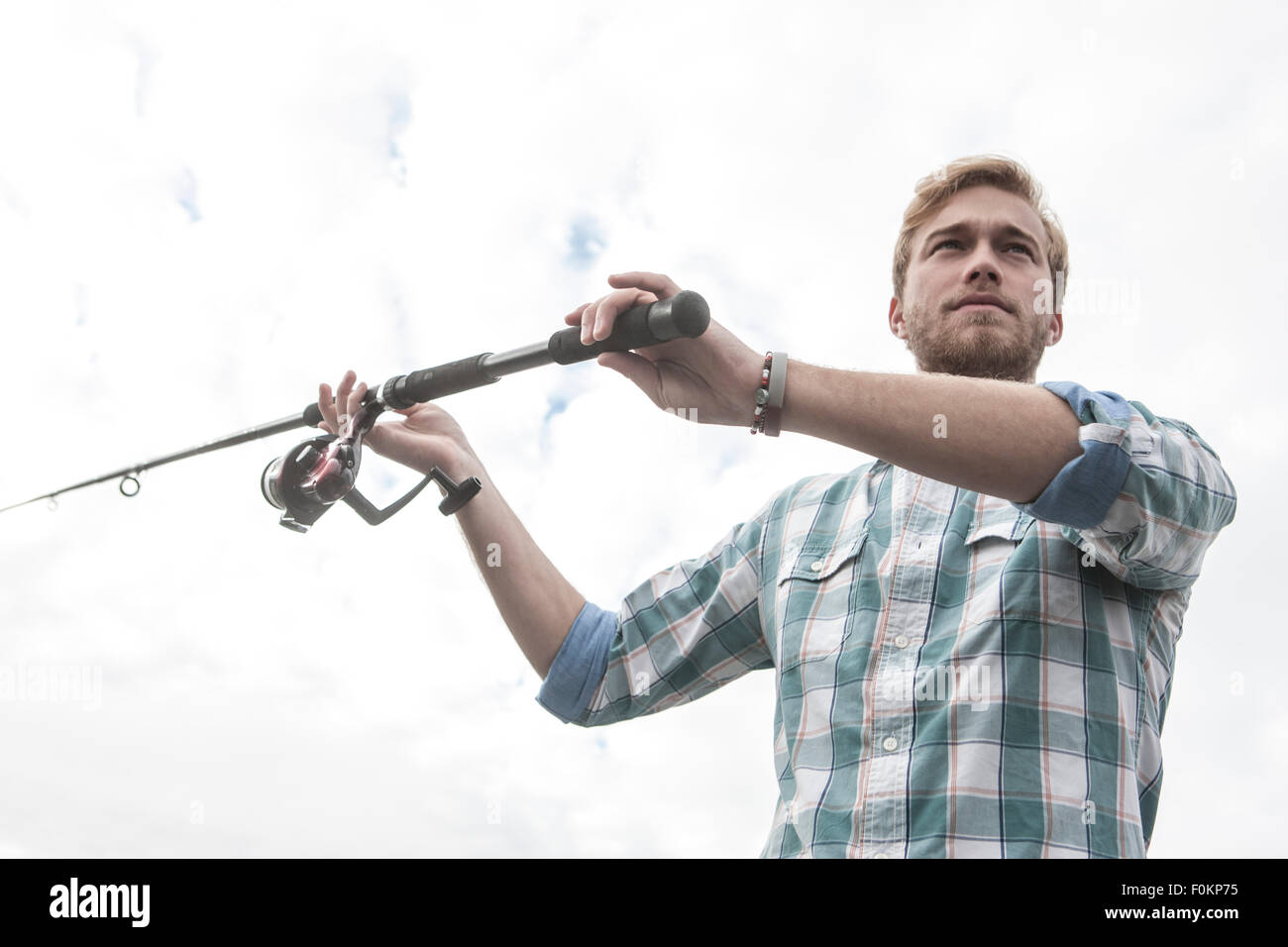 Portrait of fishing young man Stock Photo - Alamy