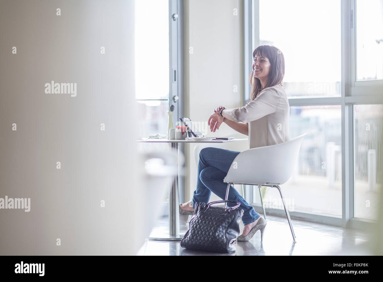 Woman waiting in a restaurant Stock Photo - Alamy