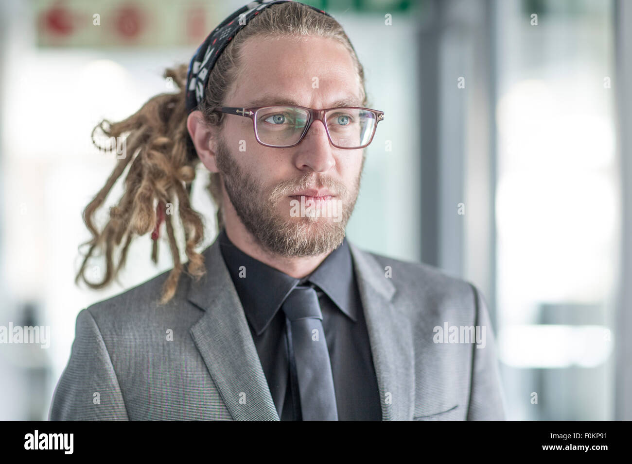 Portrait of businessman with dreadlocks wearing suit Stock Photo - Alamy