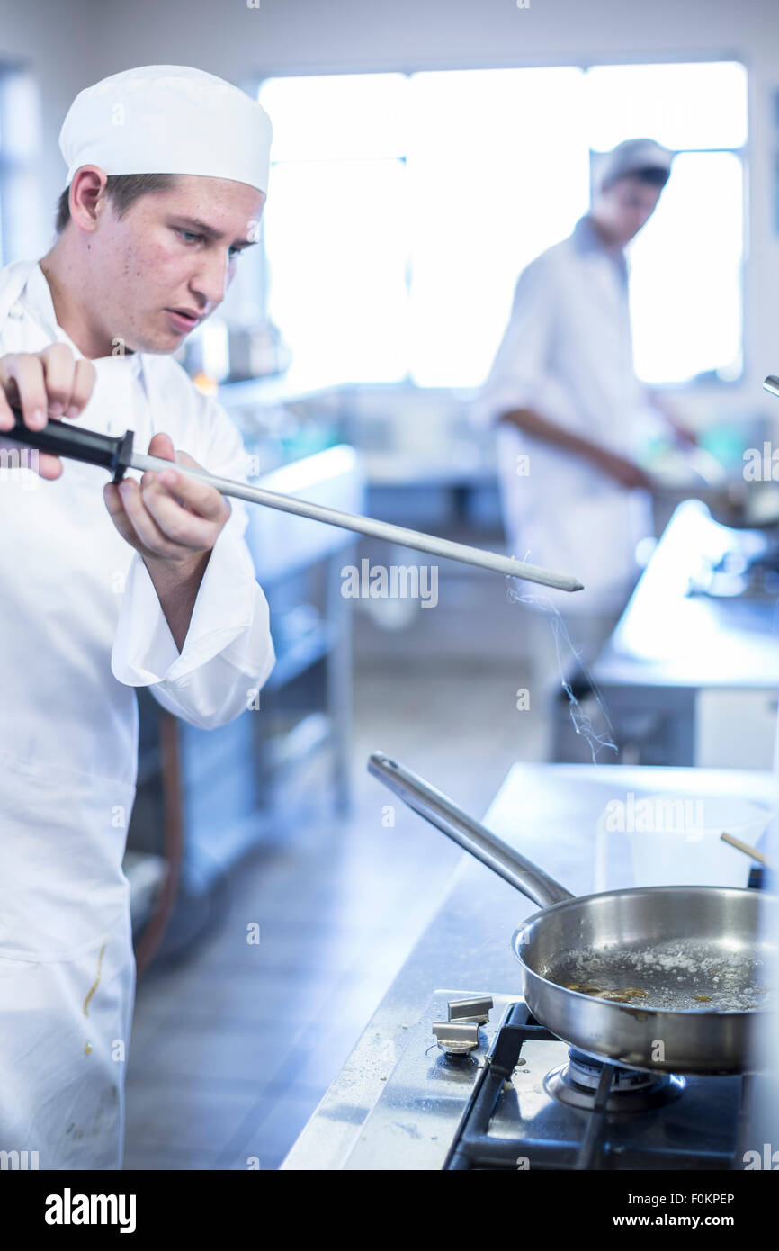 Teenager cooking in canteen kitchen Stock Photo - Alamy