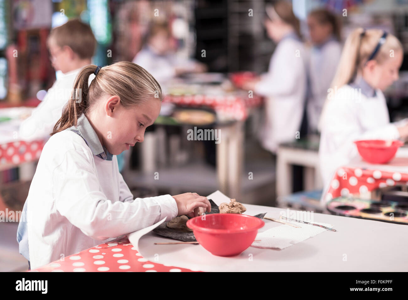 Girl working on modeling clay in art class at school Stock Photo - Alamy