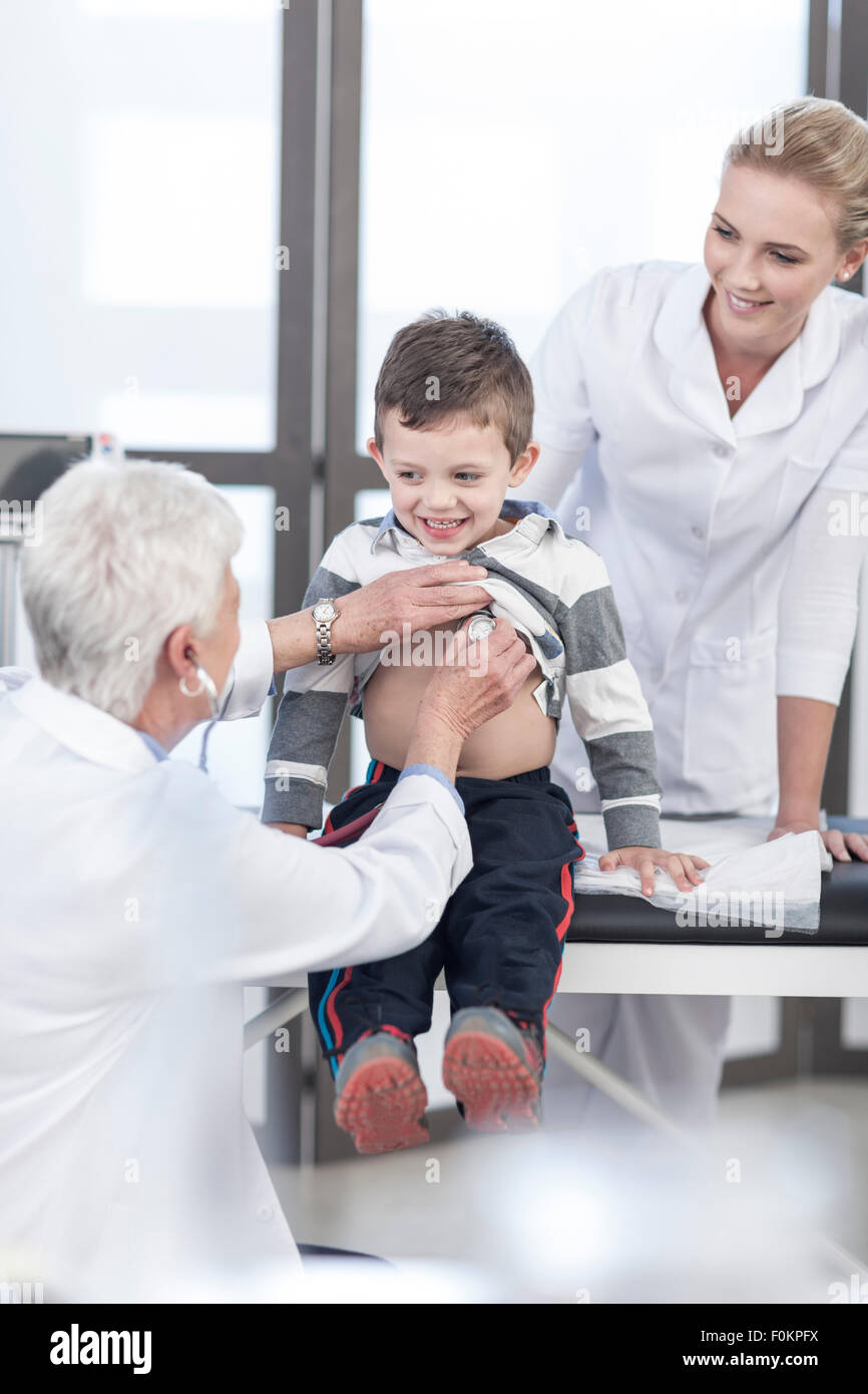 Doctor examining little boy Stock Photo - Alamy