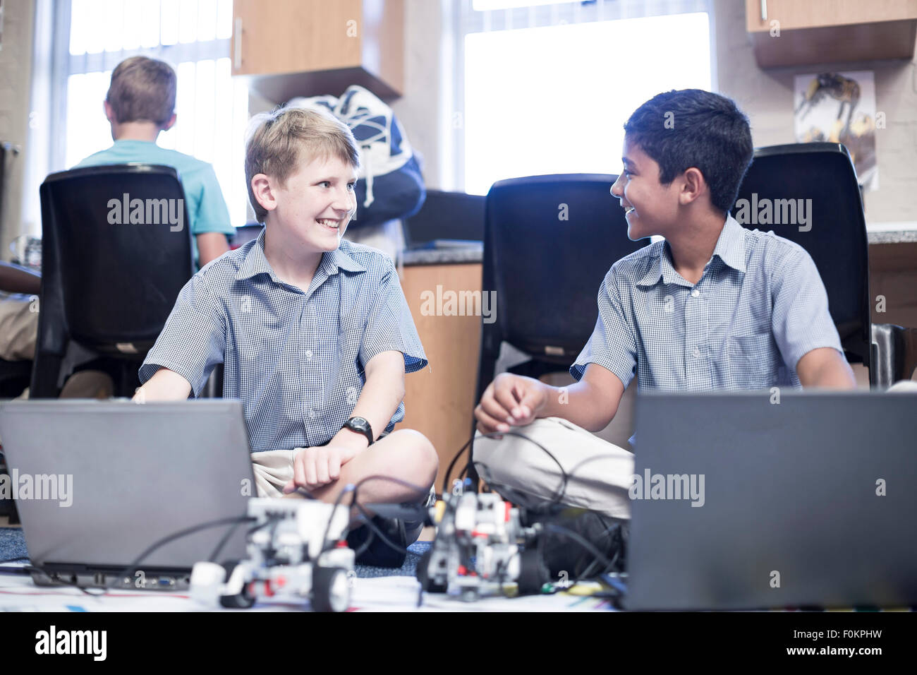 Two smiling schoolboys with laptops in robotics class Stock Photo - Alamy