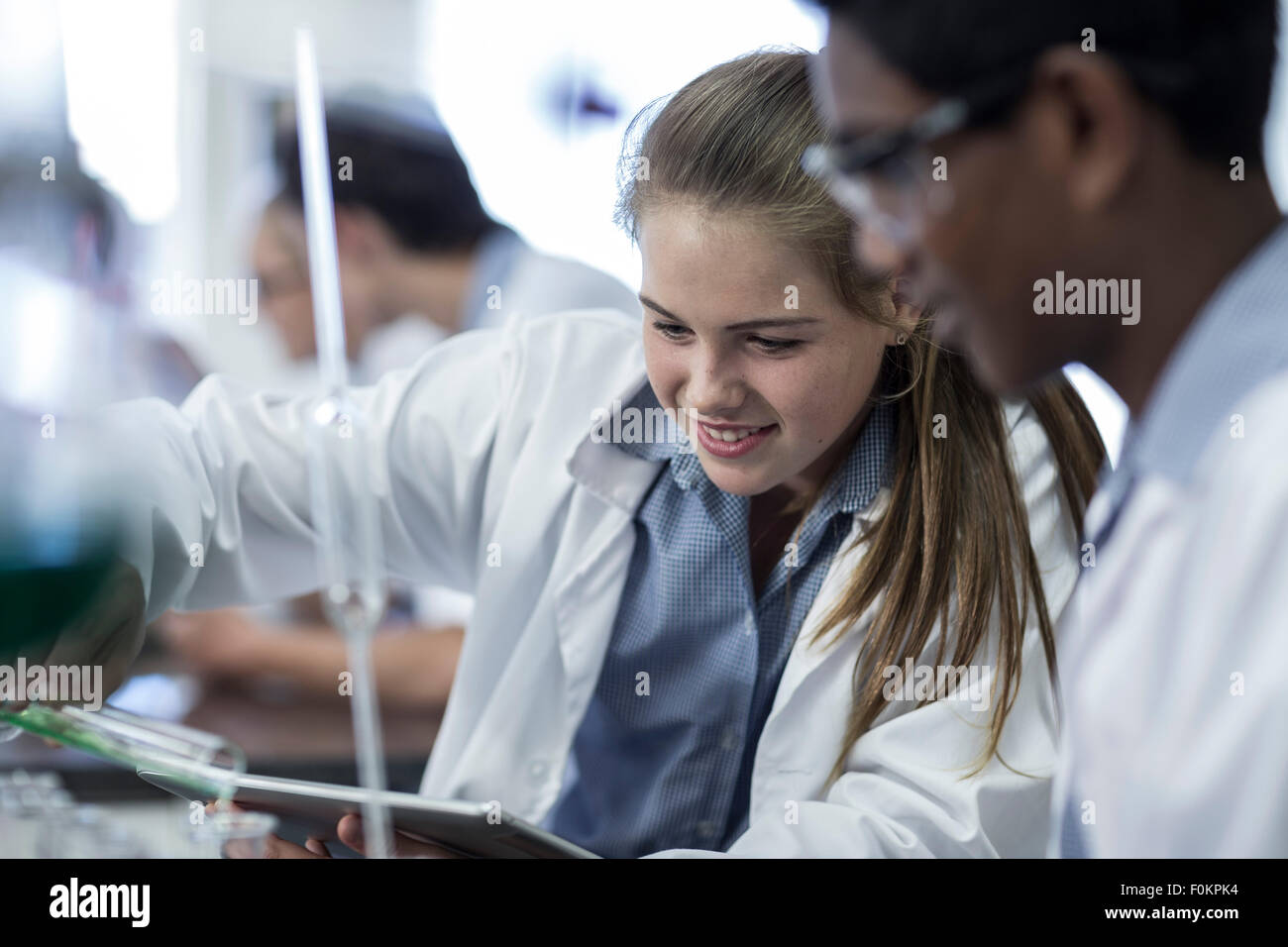 Two students in chemistry class working together Stock Photo - Alamy