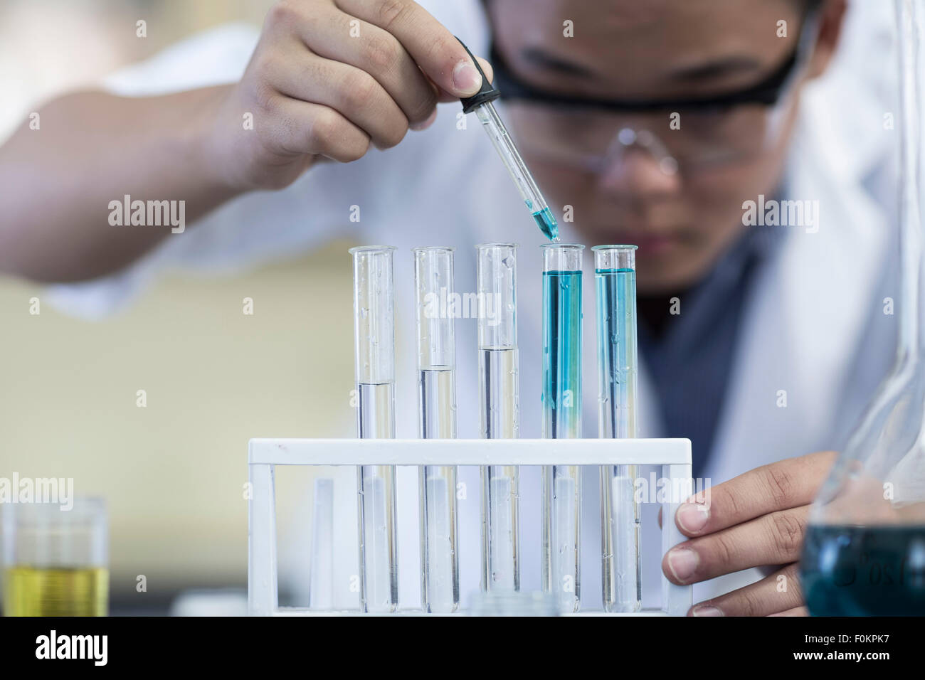 Student in chemistry class pipetting liquid into test tube Stock Photo ...