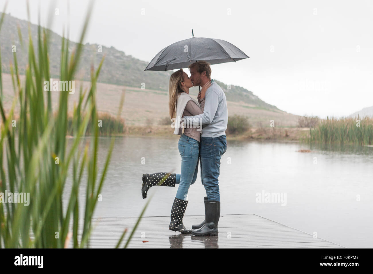 Romantic couple kissing in rain hi-res stock photography and images - Alamy
