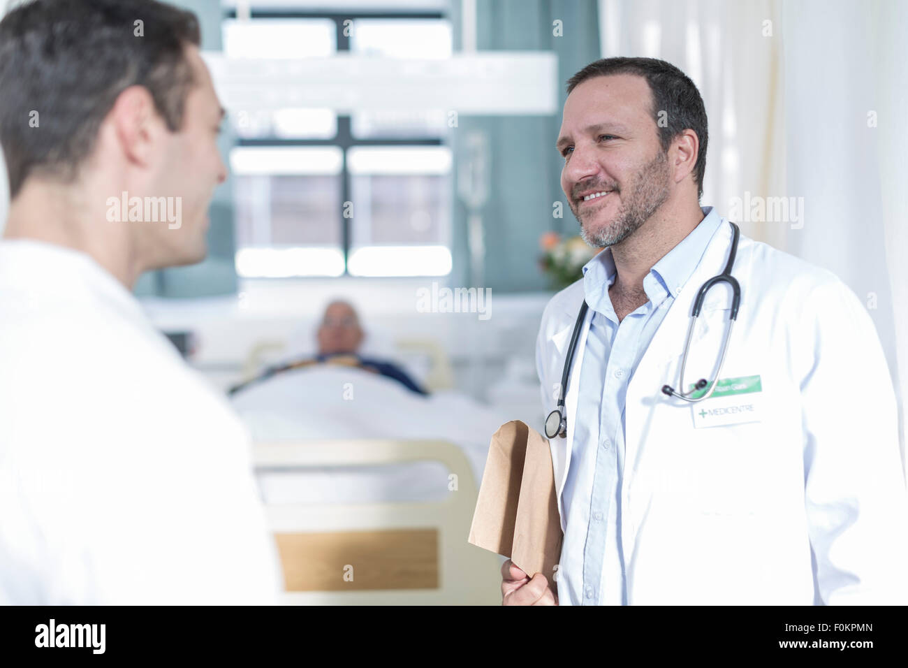 Two doctors talking in a hospital room Stock Photo - Alamy