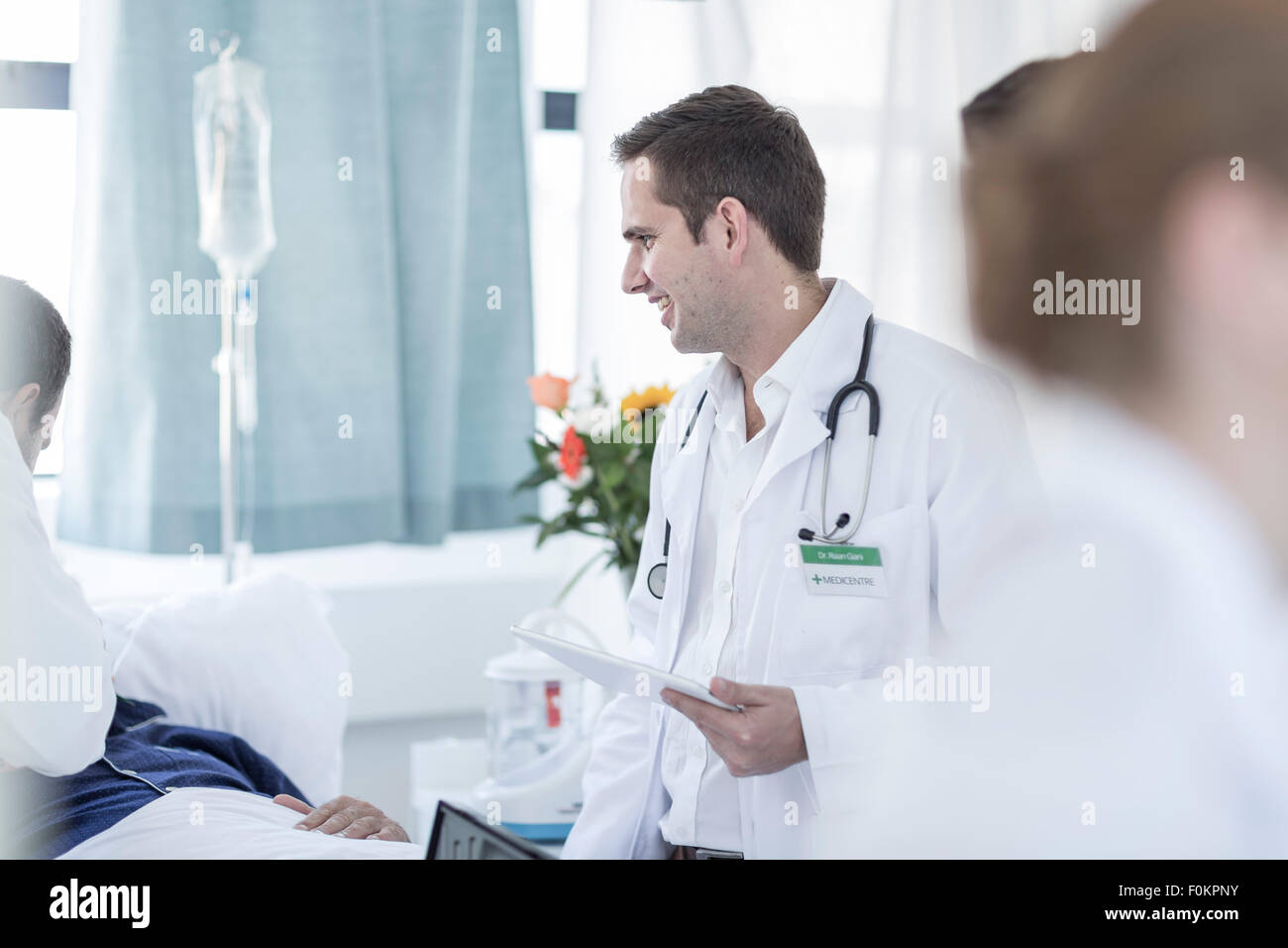 Doctors examining patient in a hospital room Stock Photo - Alamy