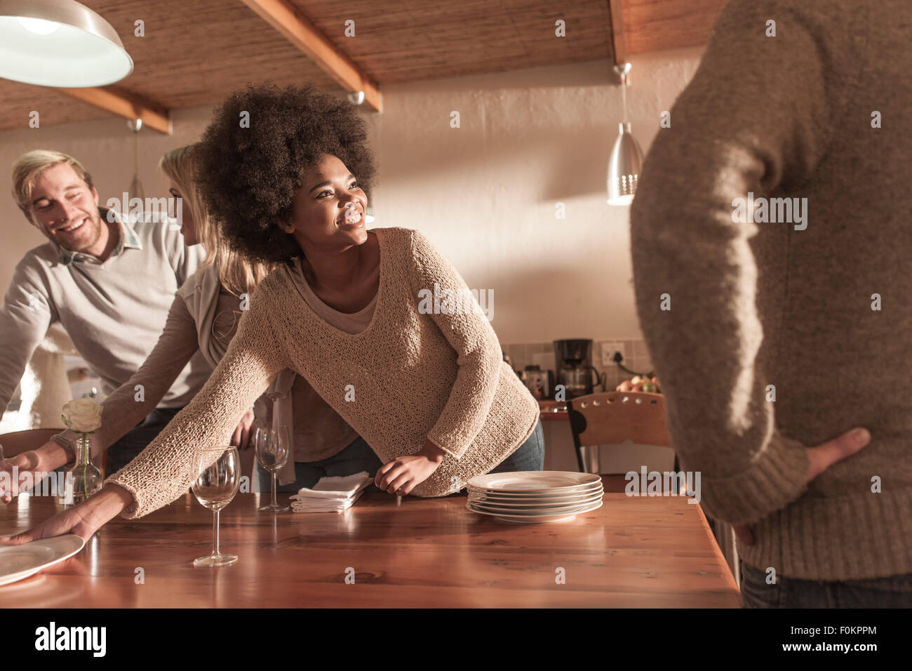 Friends setting a table together Stock Photo - Alamy
