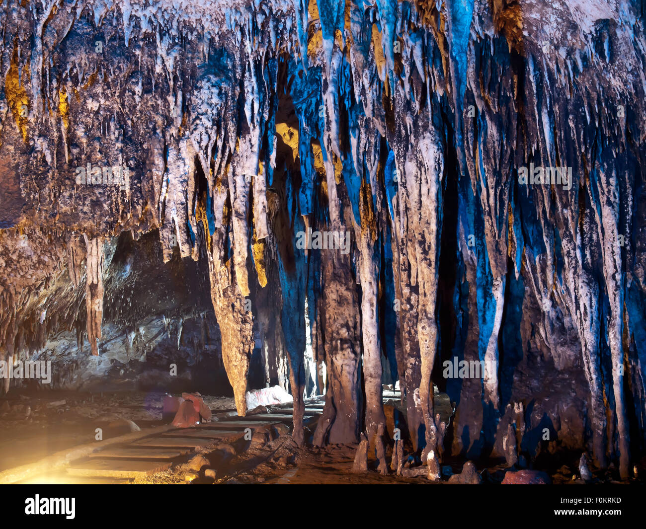 Stalactite wall illuminated with color light in Tham Khao Bin cave ...