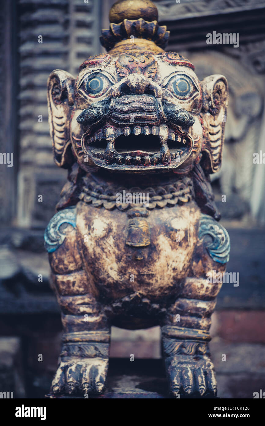 Stone lion at the entrance of a temple in Bhaktapur, Nepal. The old ...