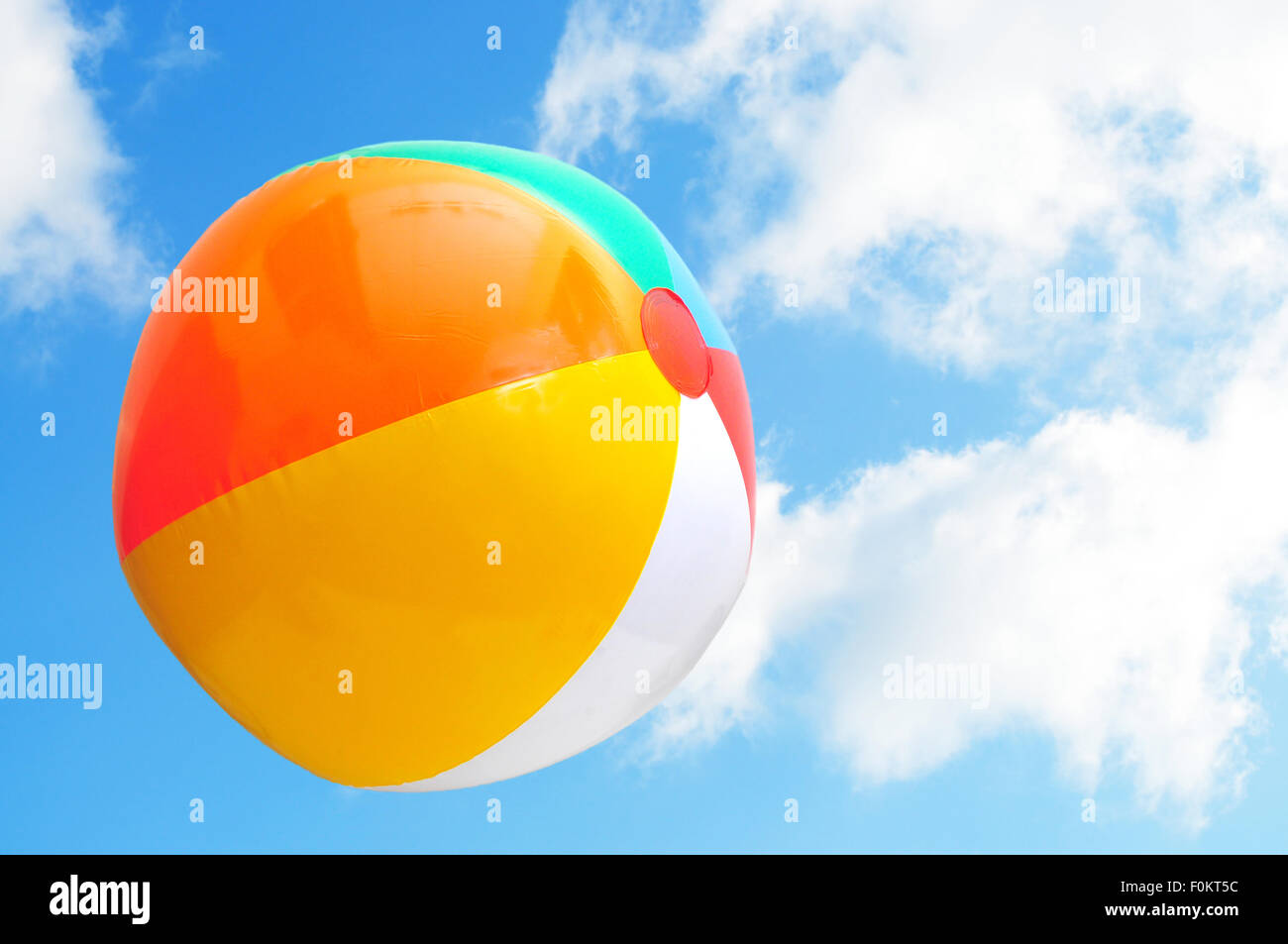 Colorful beach ball up in the air with beautiful blue sky Stock Photo ...