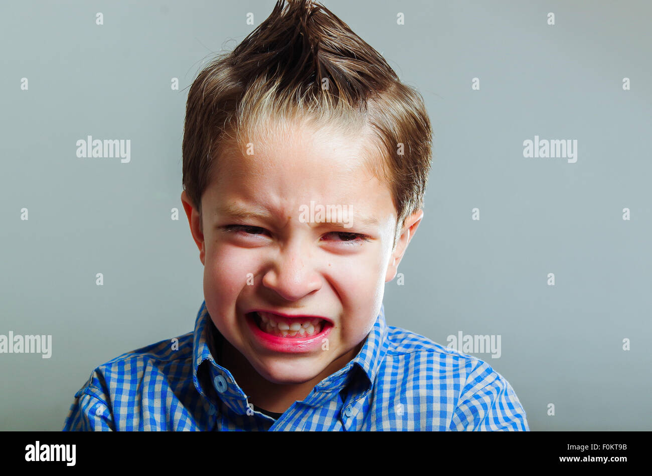 Sweet little boy gesturing anger Stock Photo - Alamy