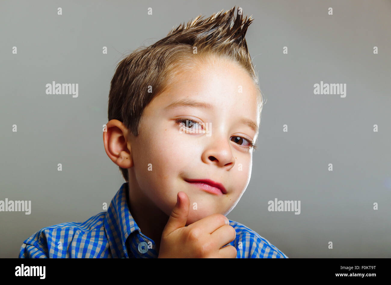 Sweet little boy gesturing idea Stock Photo - Alamy
