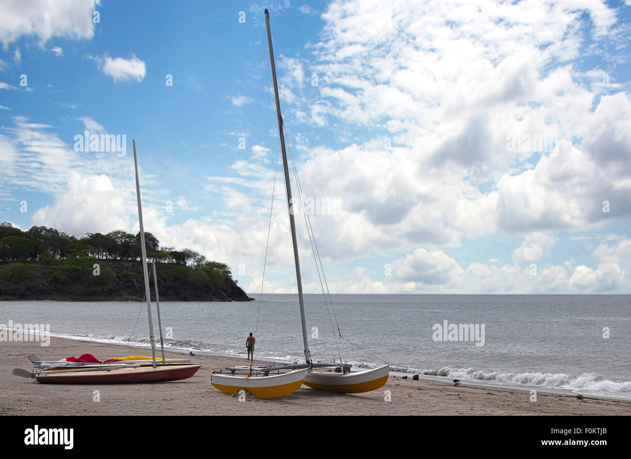 Couple of small boats at a tropical beach with natural blue sky in the ...