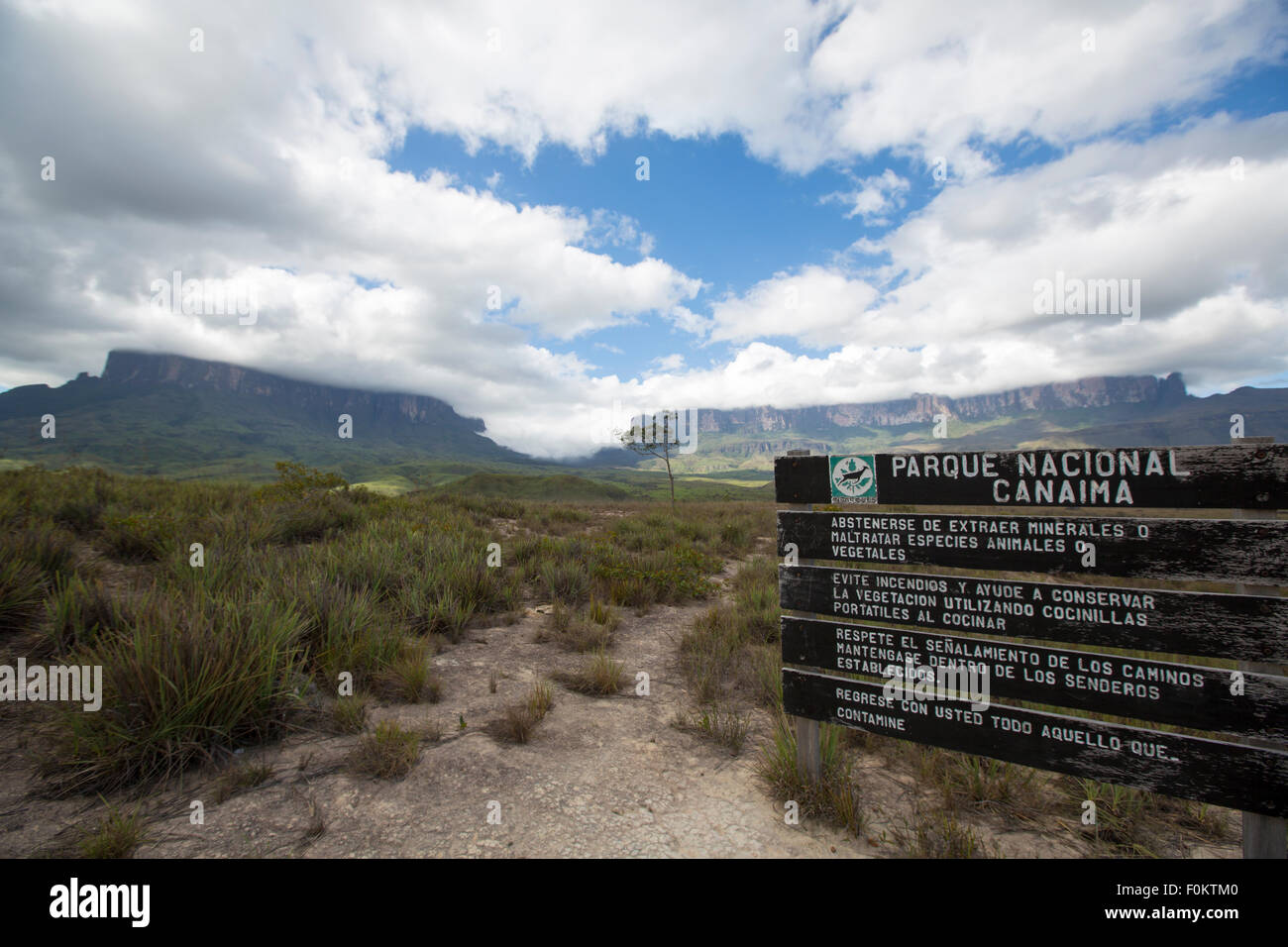 Entrance wood sign to Canaima National Park. In the background we can ...