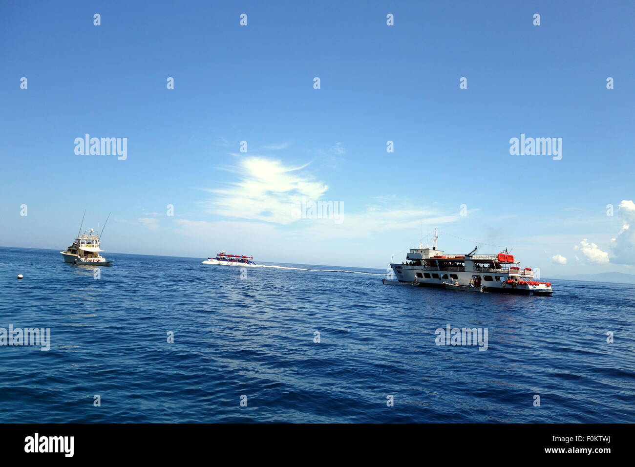 Tour boats sailing in the ocean on a clear day Stock Photo - Alamy