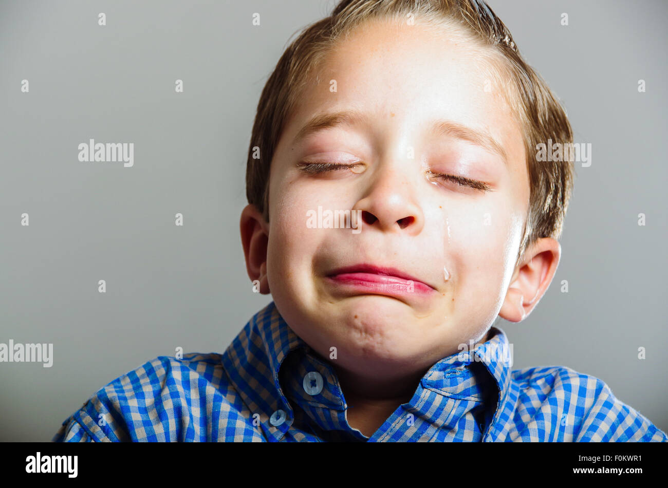 Sweet little boy gesturing sadness Stock Photo - Alamy