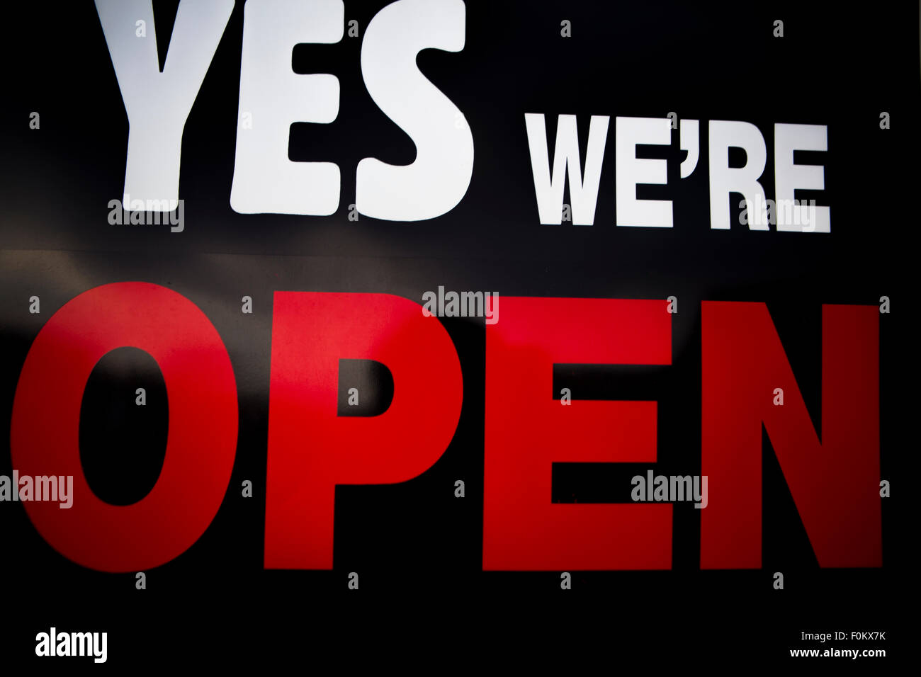 A white and red open sign isolated on black Stock Photo - Alamy