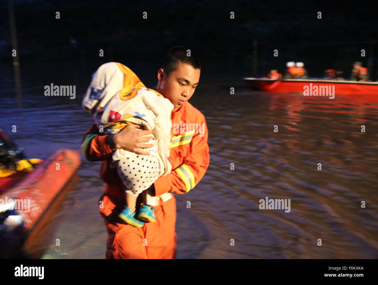 Zhenning, China's Guizhou Province. 18th Aug, 2015. A rescuer evacuates ...
