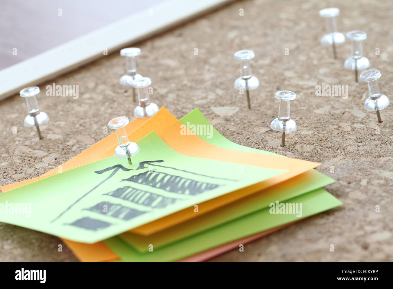 close up of pin and hand drawn business strategy graph chart on sticky ...