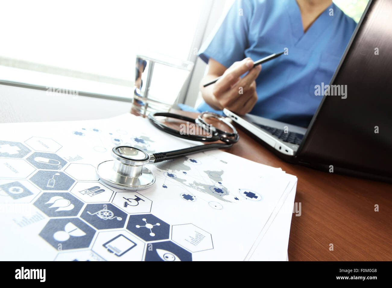 Doctor working with laptop computer in medical workspace office and ...