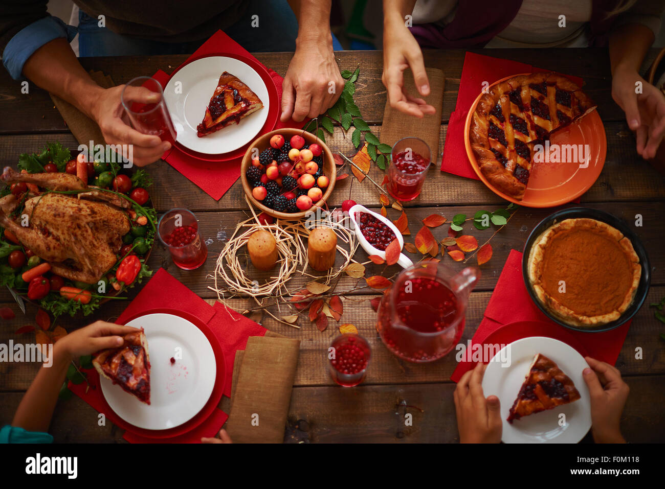 People eating a pie and drinking cranberry compote Stock Photo - Alamy