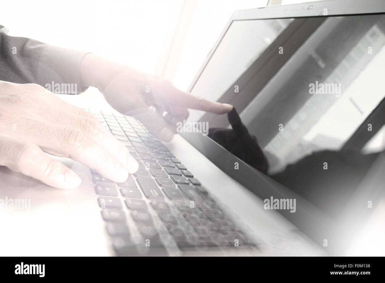 business man hand working with laptop computer and touching on screen ...