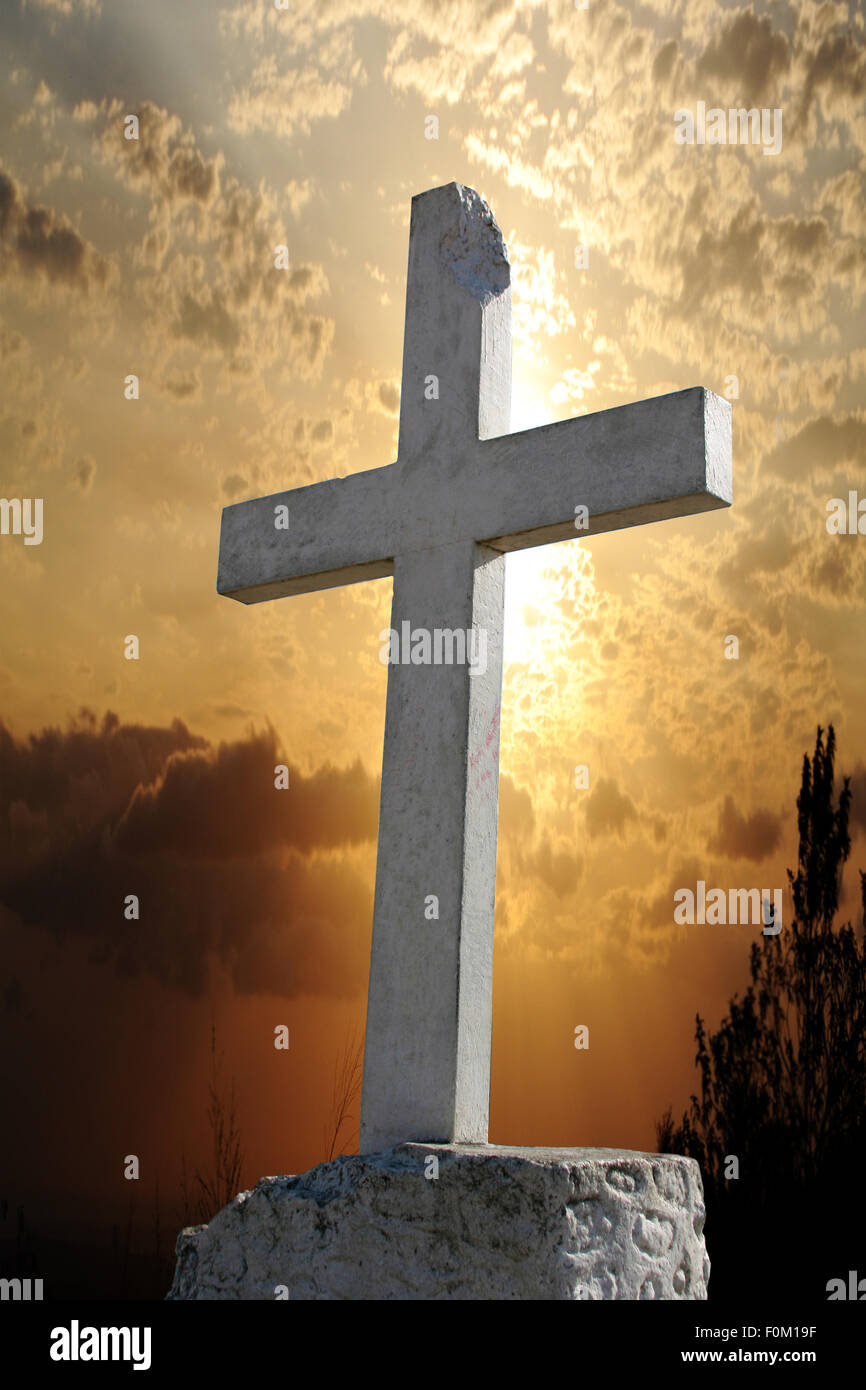 White concrete cross with a beautiful sunrise as background Stock Photo ...