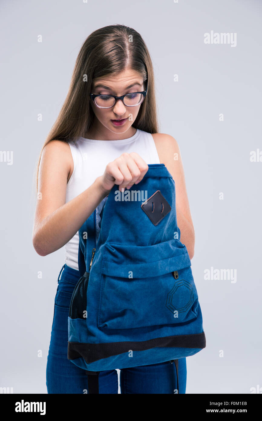 Portrait of a female teenager in glasses searching something in ...