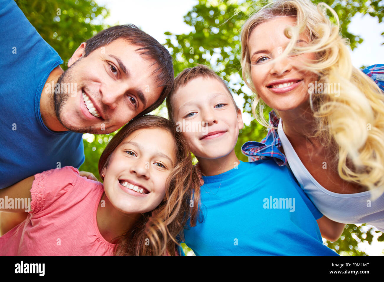 Happy faces of four family members Stock Photo - Alamy