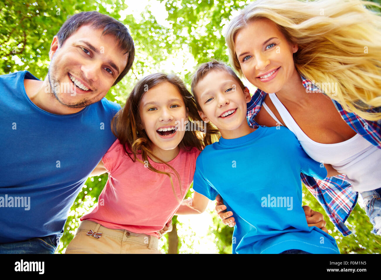 Family of four posing with happy faces Stock Photo - Alamy