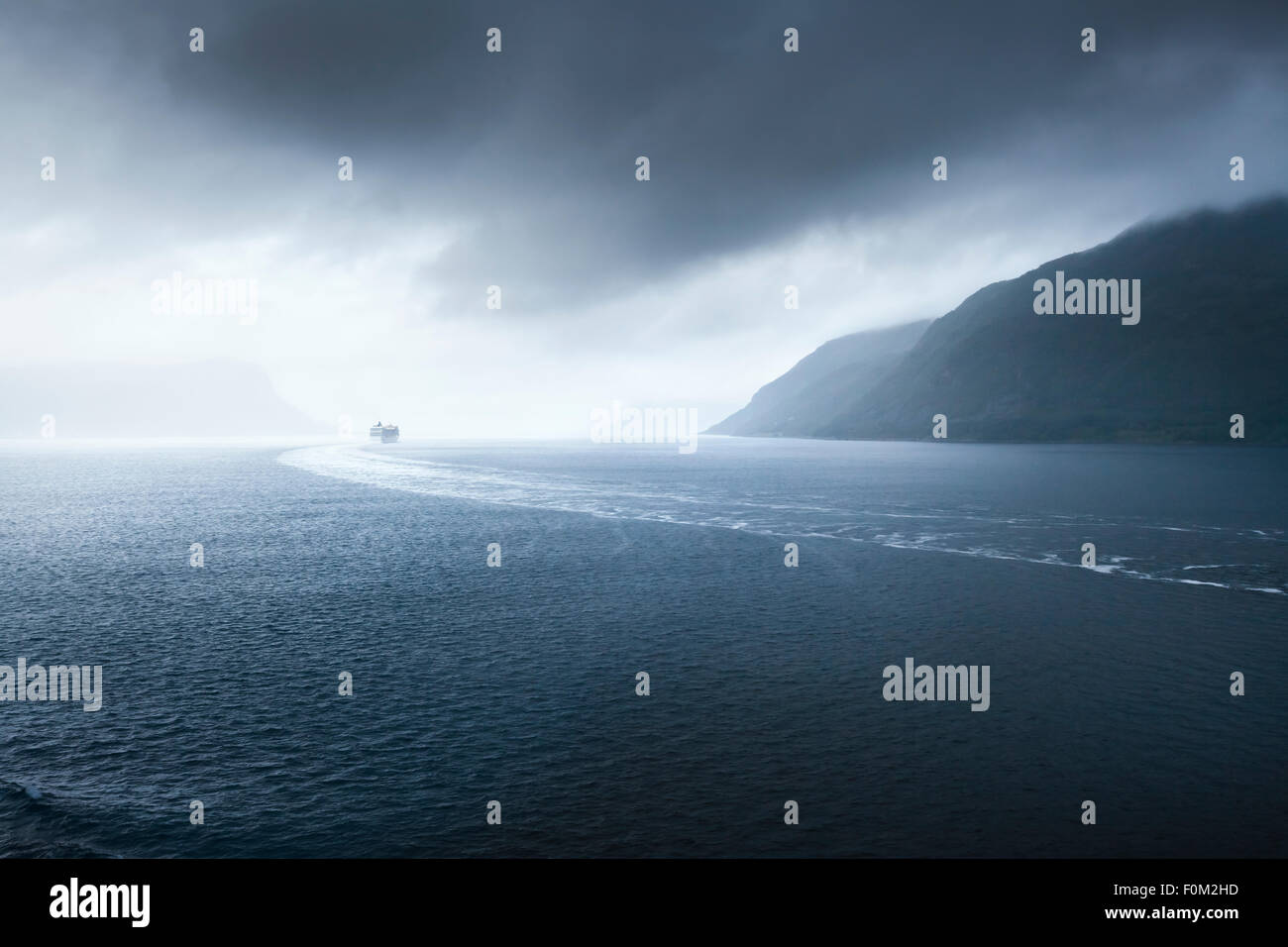 Cruise ship with rain clouds in a fjord, Norway Stock Photo - Alamy