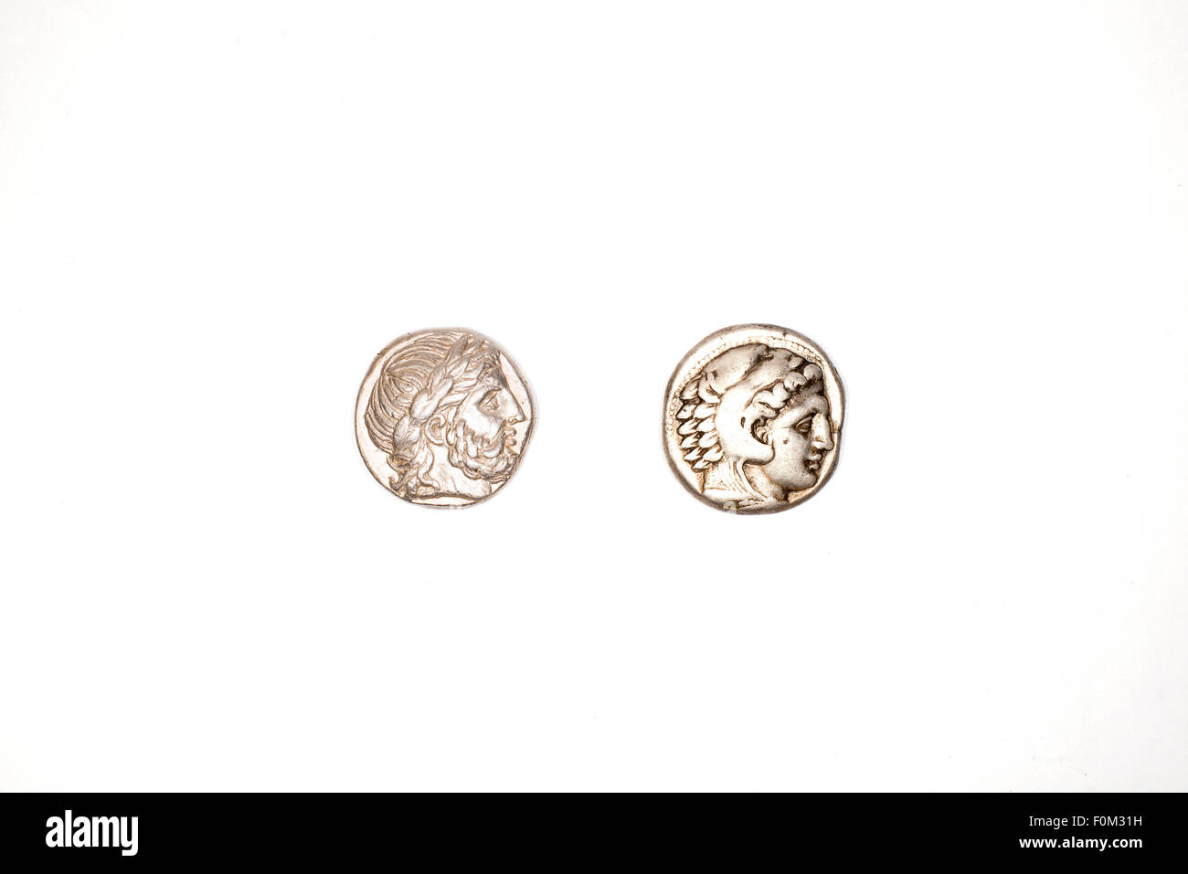 Silver antique coins of Alexander the Great and Philip II on a white ...