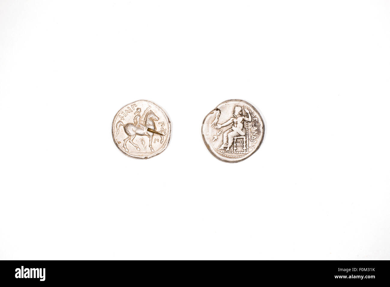 Silver antique coins of Alexander the Great and Philip II on a white ...