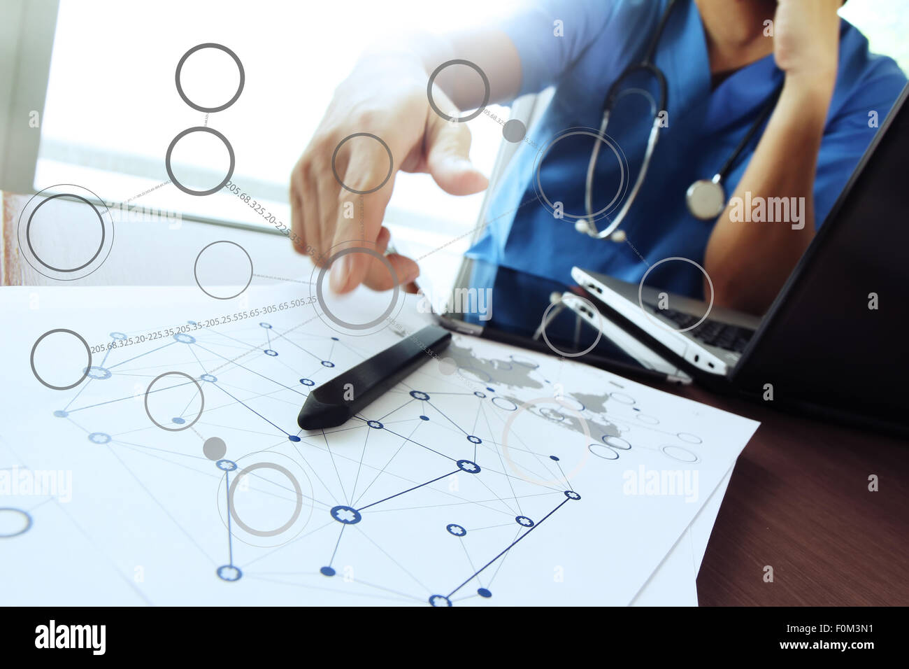 Doctor working with laptop computer in medical workspace office and ...