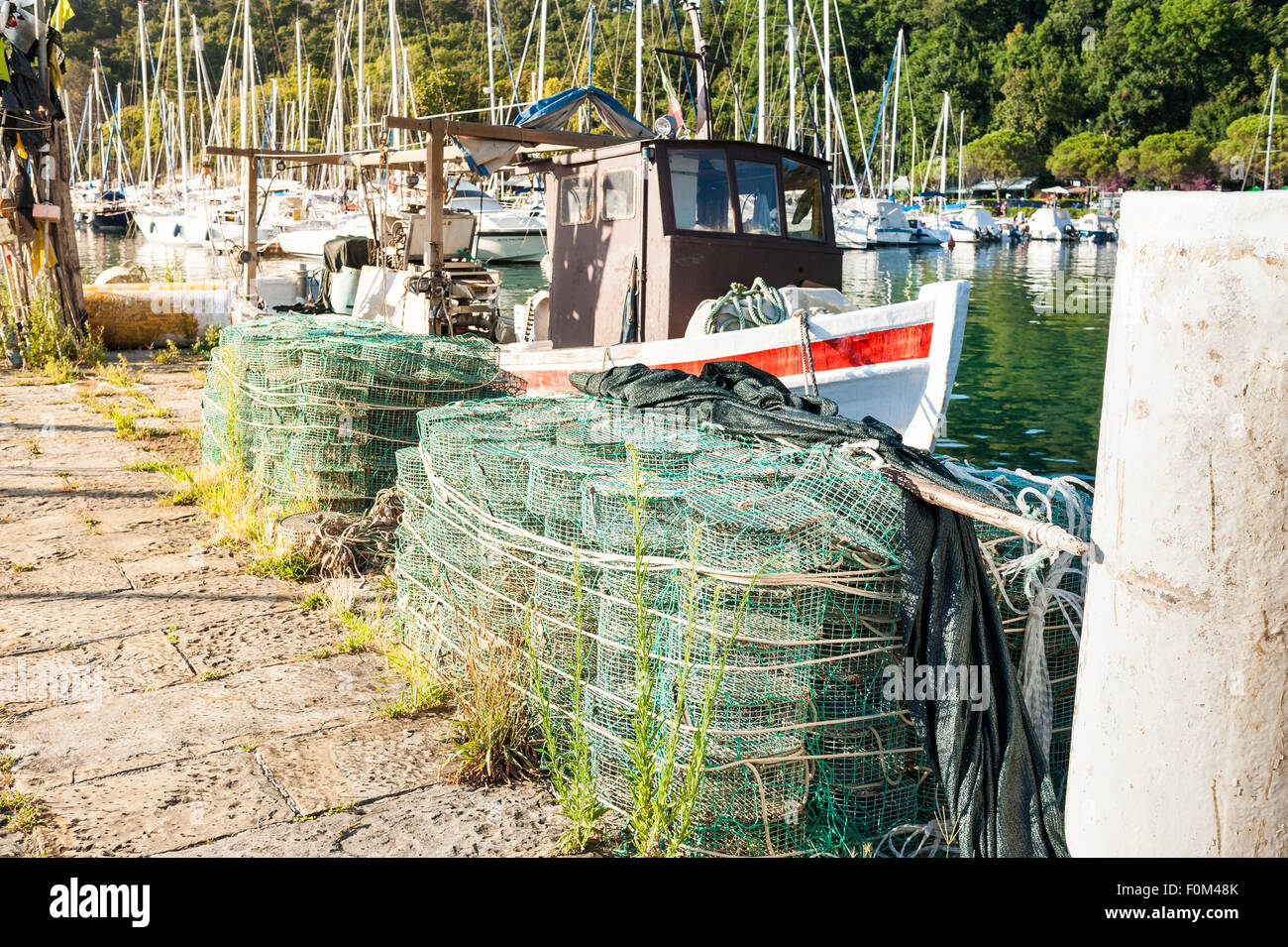 Fishing creels on the pier in the background fishing boat Stock Photo ...