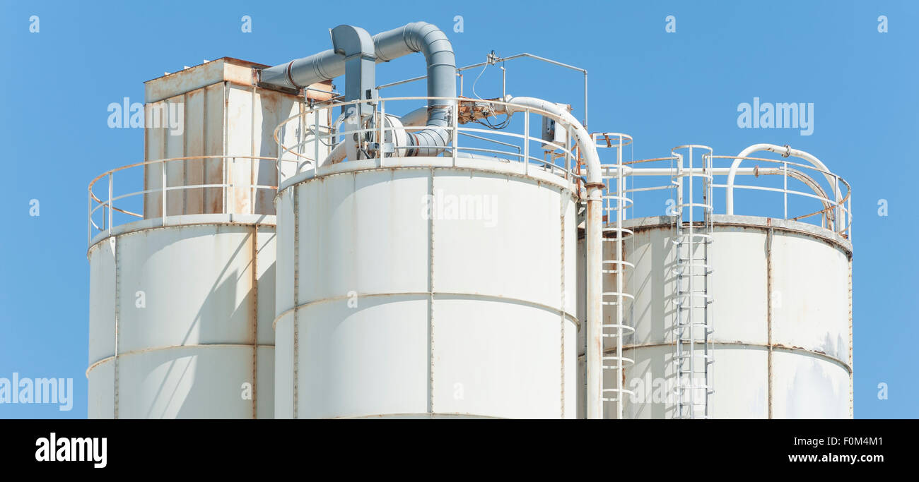 White silos for the storage of lime and cement Stock Photo - Alamy