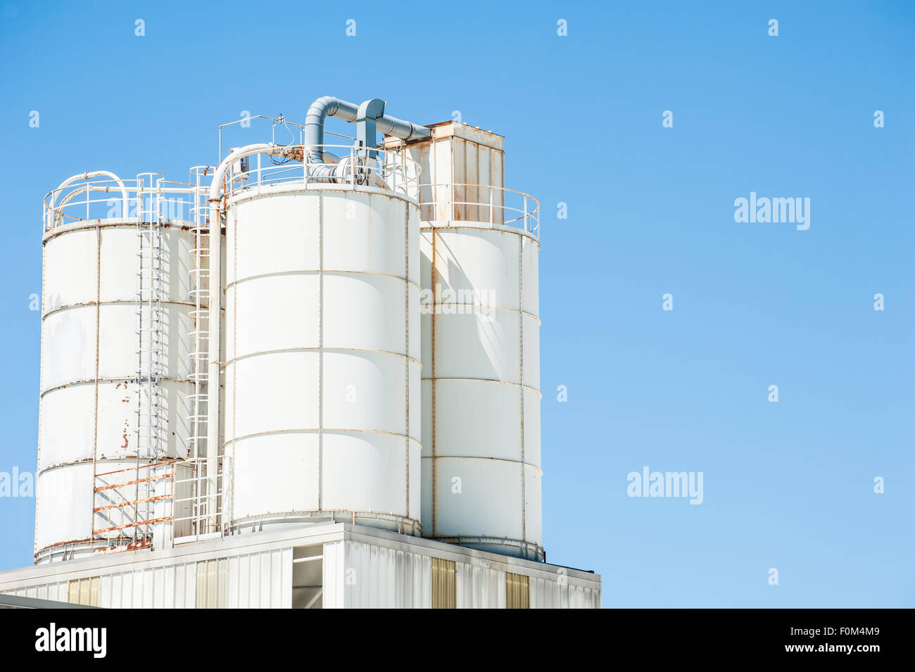 White silos for the storage of lime and cement Stock Photo - Alamy