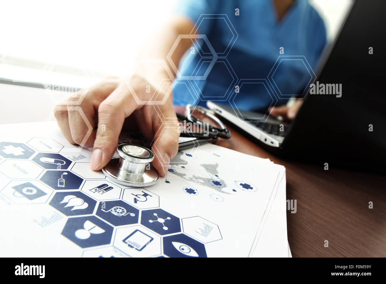Doctor working with laptop computer in medical workspace office and ...