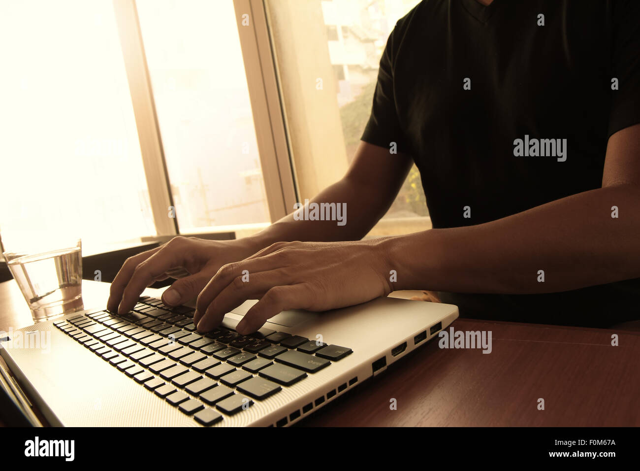 Young creative designer man working at office with computer laptop as ...