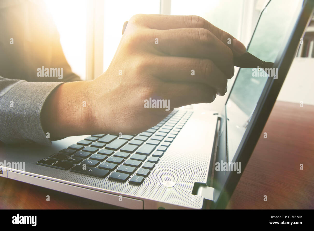 business man hand working with laptop computer and touching on screen ...