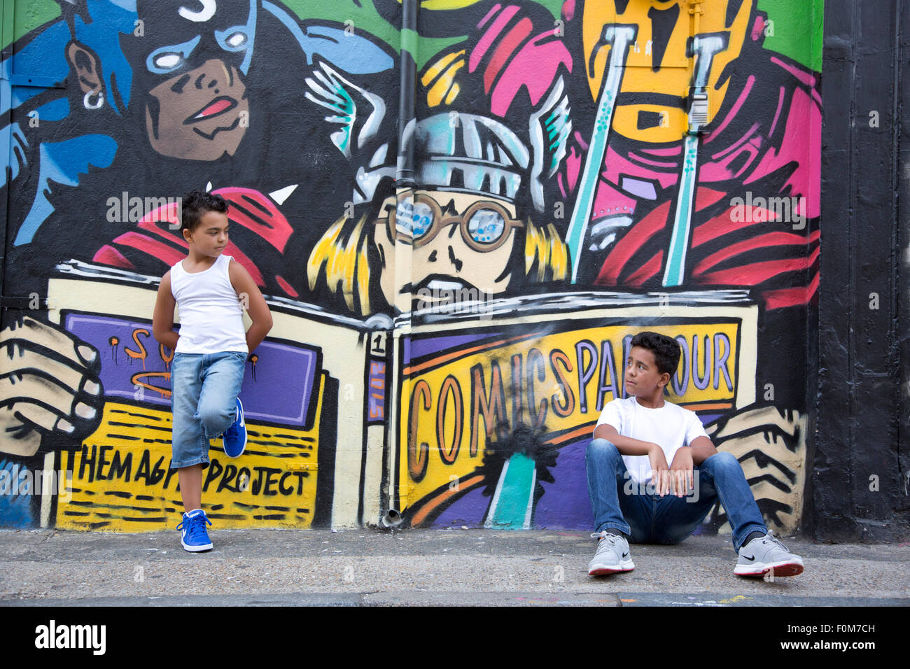 2 boys standing in front of a graffiti wall UK Stock Photo - Alamy