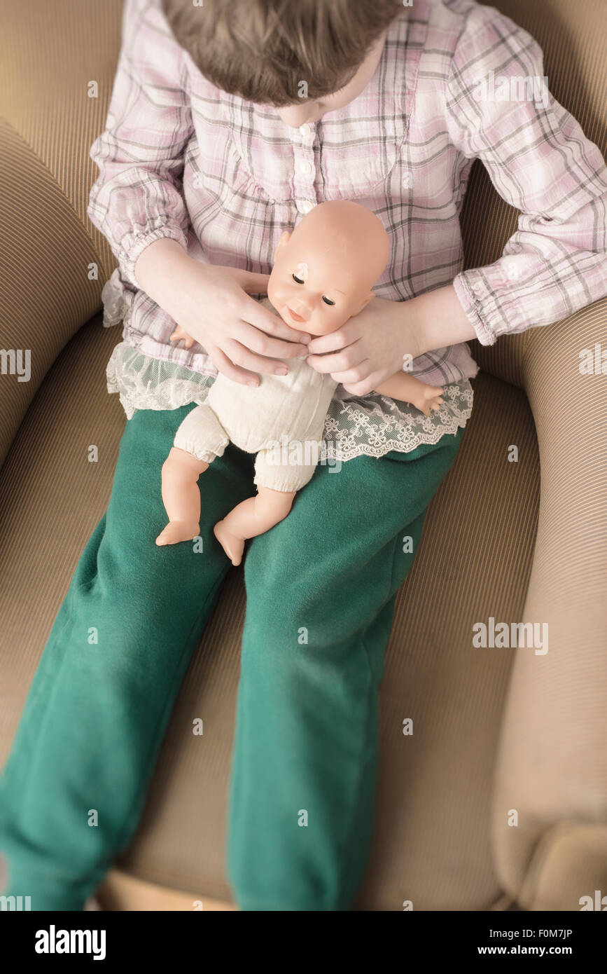 Girls holding dolls hi-res stock photography and images - Alamy