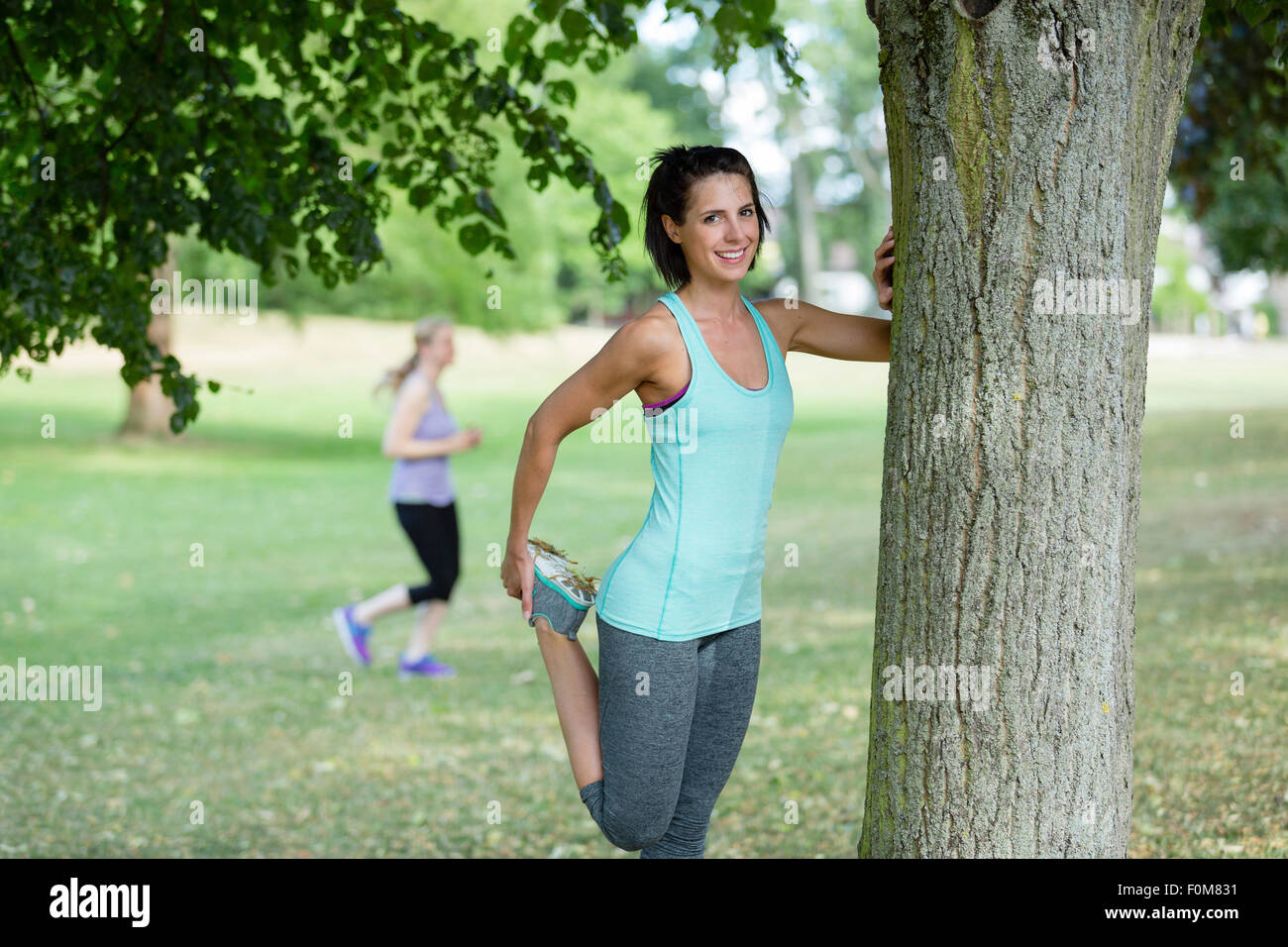 Two women stretch, warm up Stock Photo - Alamy
