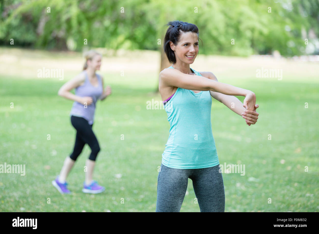 Two young women exercising stretching hi-res stock photography and ...