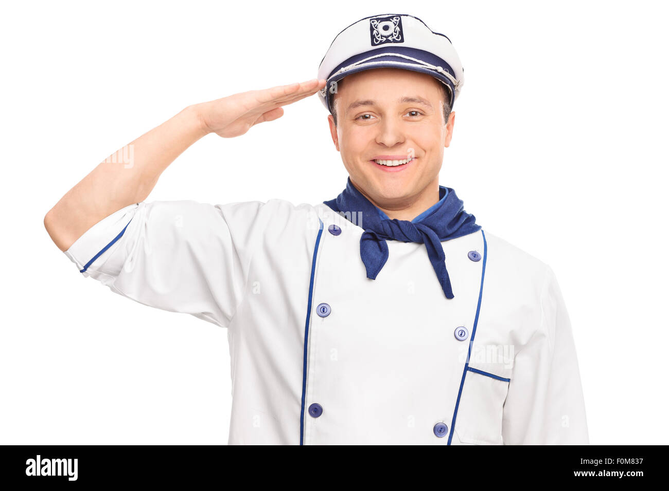 Cheerful young male sailor saluting towards the camera and smiling ...
